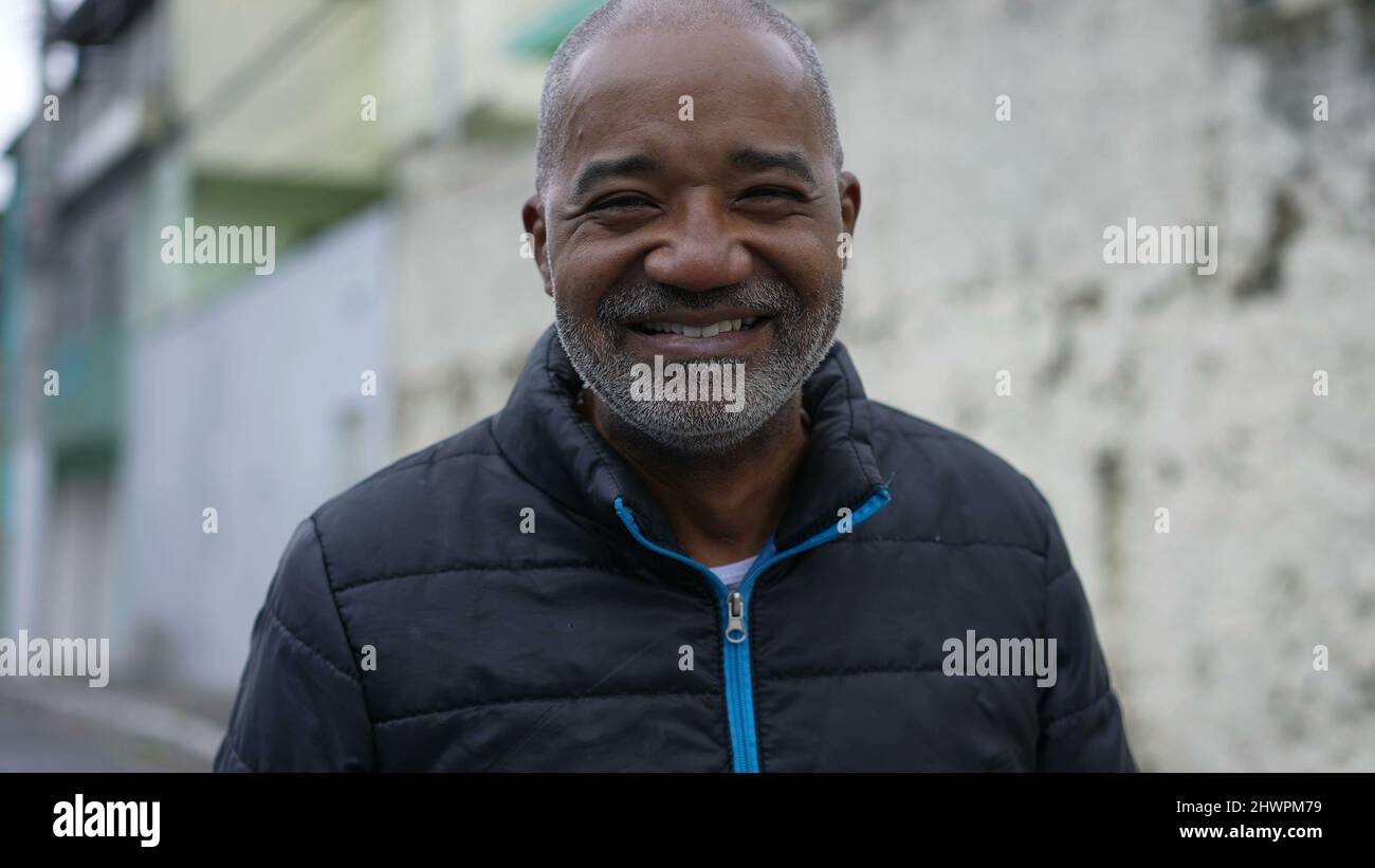 A senior African American person walking outside in street portrait ...