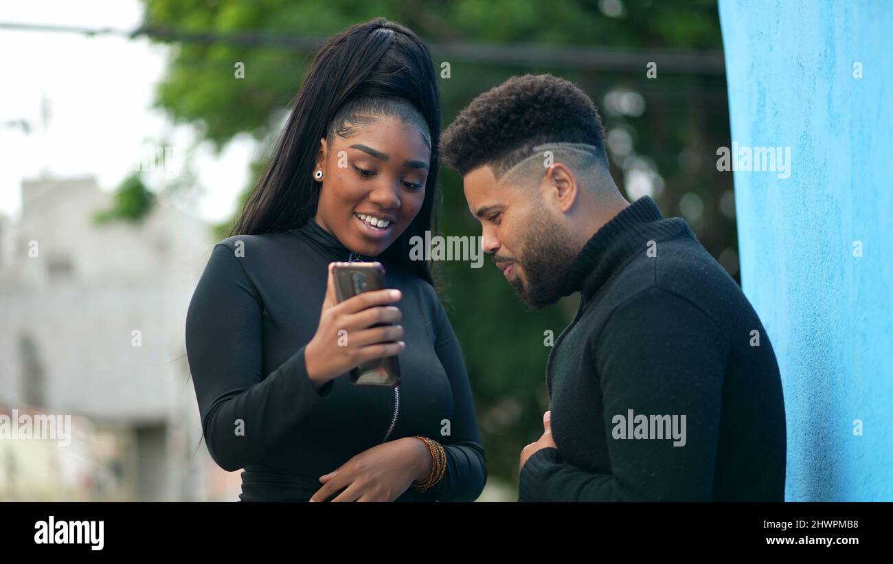 Girl sharing cellphone screen content online on phone two people ...