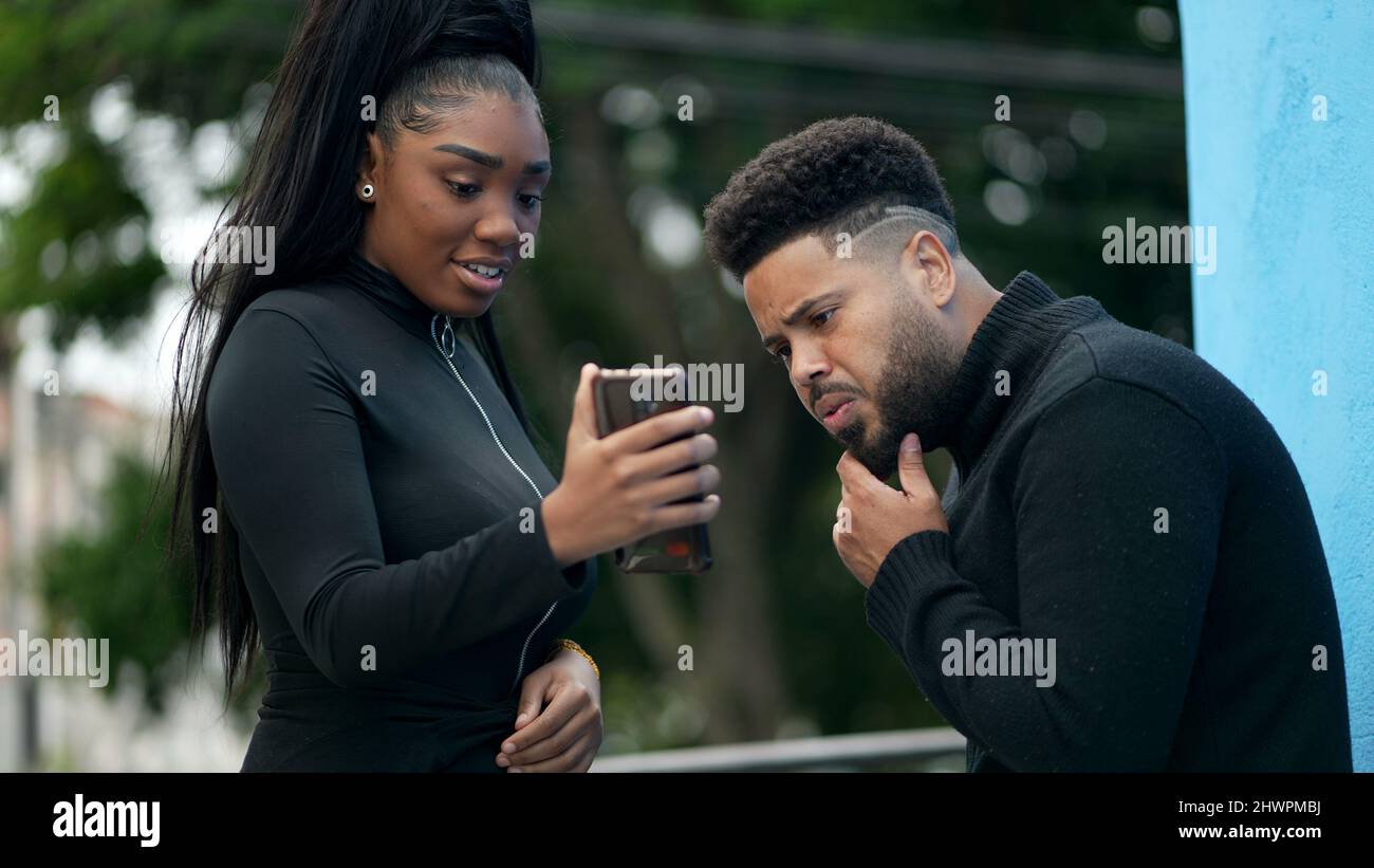 Girl sharing cellphone screen content online on phone two people ...