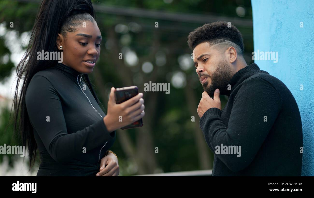 Girl sharing cellphone screen content online on phone two people ...