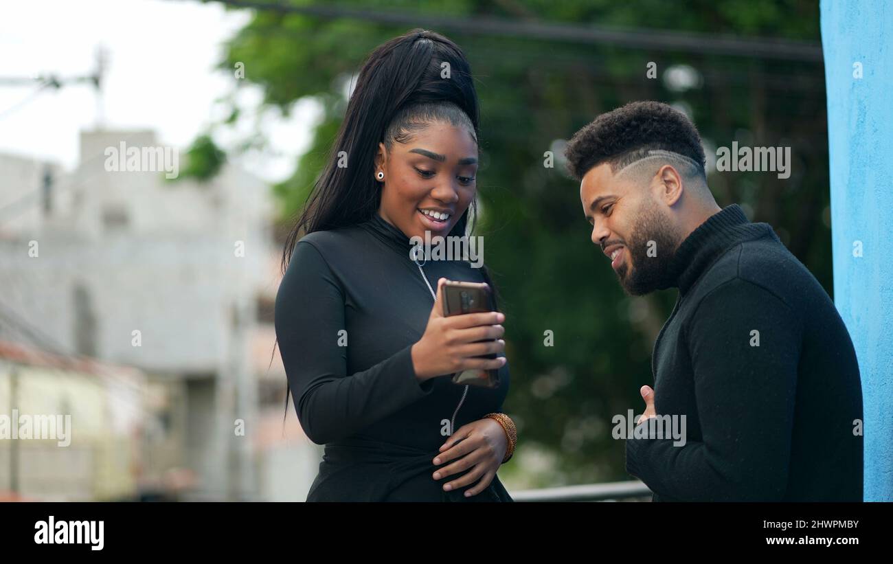 Girl sharing cellphone screen content online on phone two people ...