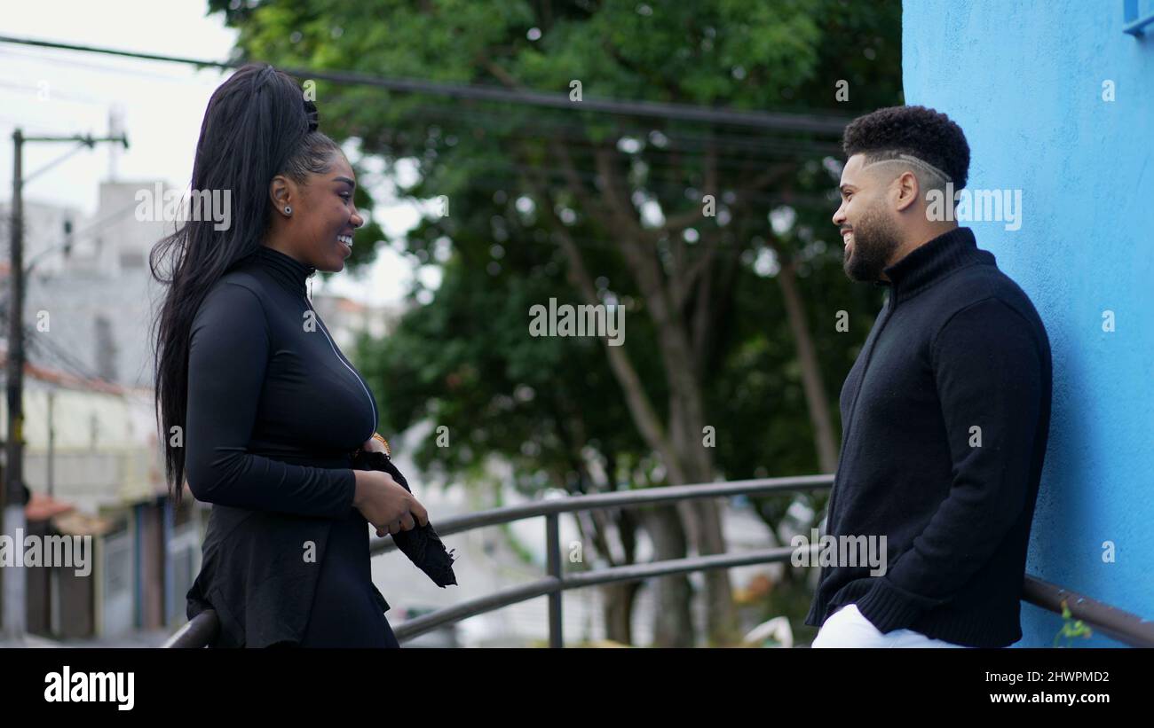 Man and woman hanging out together conversation in street candid people ...