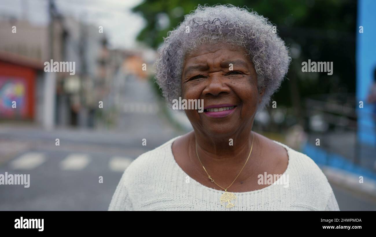 Portrait of a senior 80s Brazilian woman walking outside in street ...
