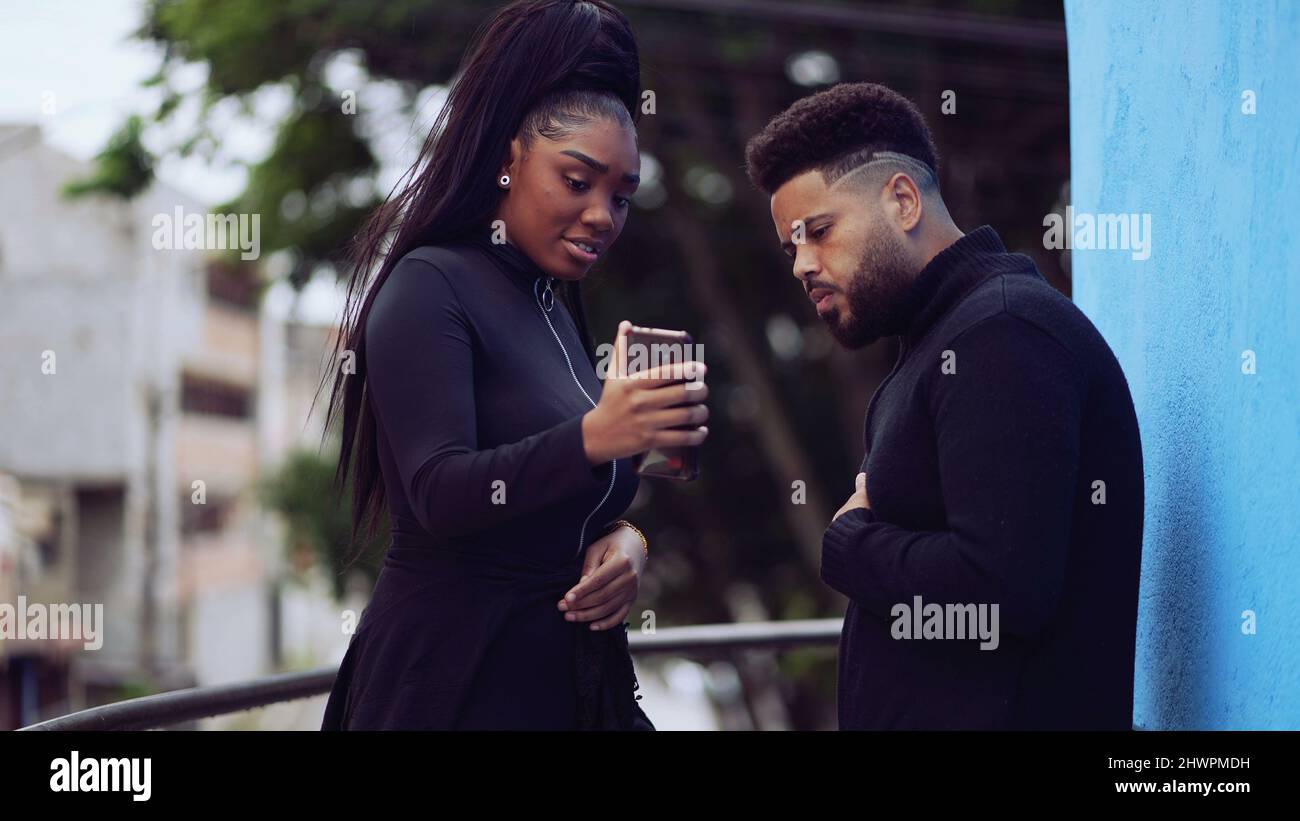Two people looking at phone screen person showing content online Stock ...