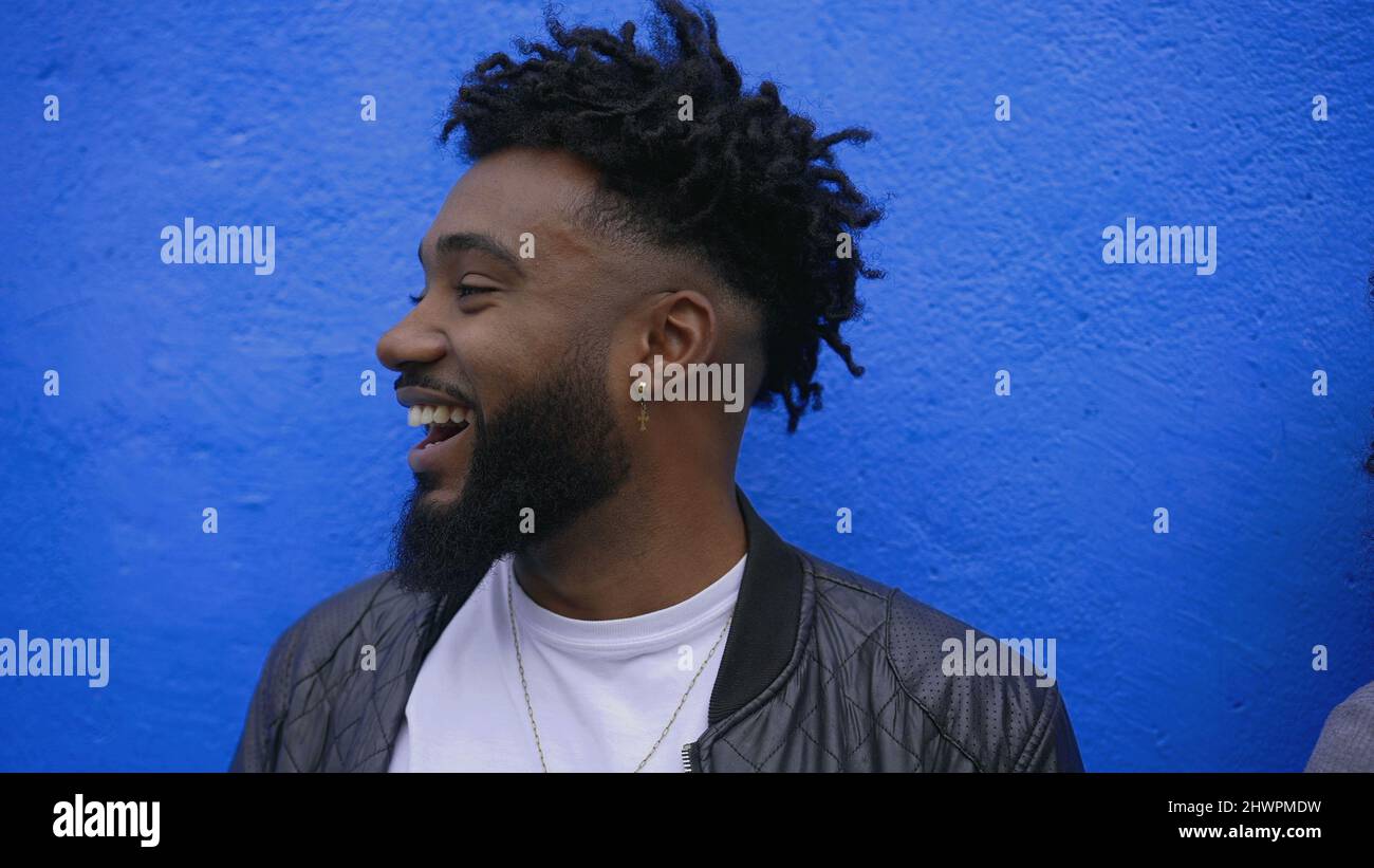 Portrait of a young Brazilian man smiling at camera Stock Photo - Alamy