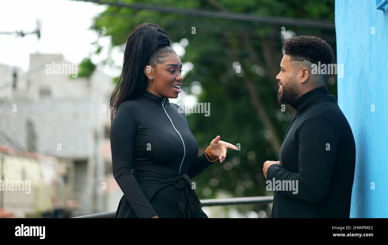 Two friends chatting outside man and woman friendship Stock Photo - Alamy