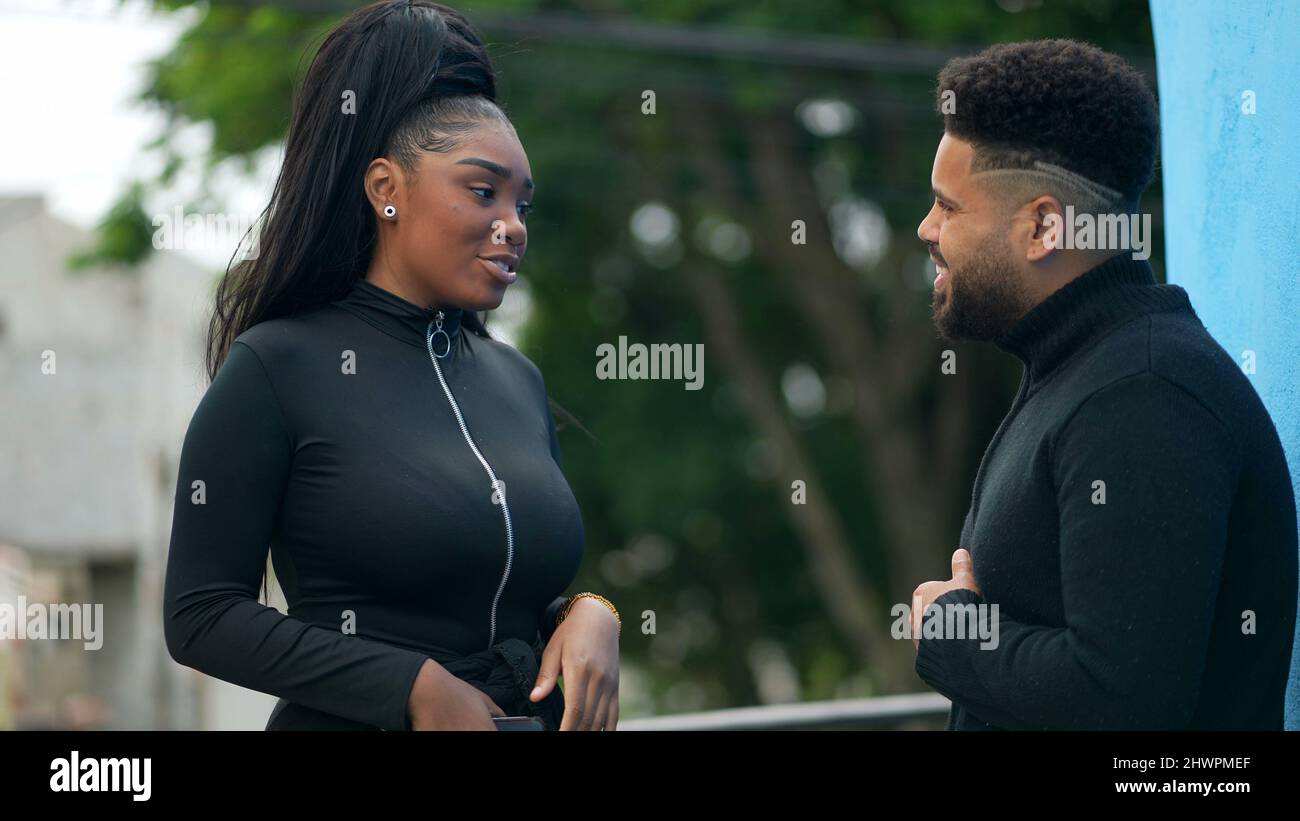 Two people talking in conversation outside in urban street Stock Photo ...