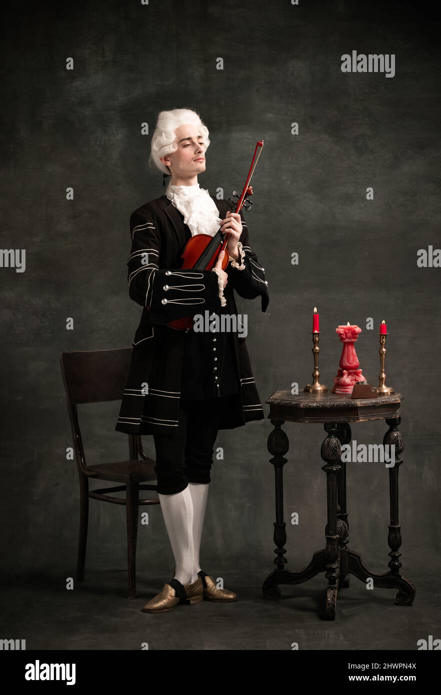 Portrait of young man wearing wig and vintage medieval outfit like ...