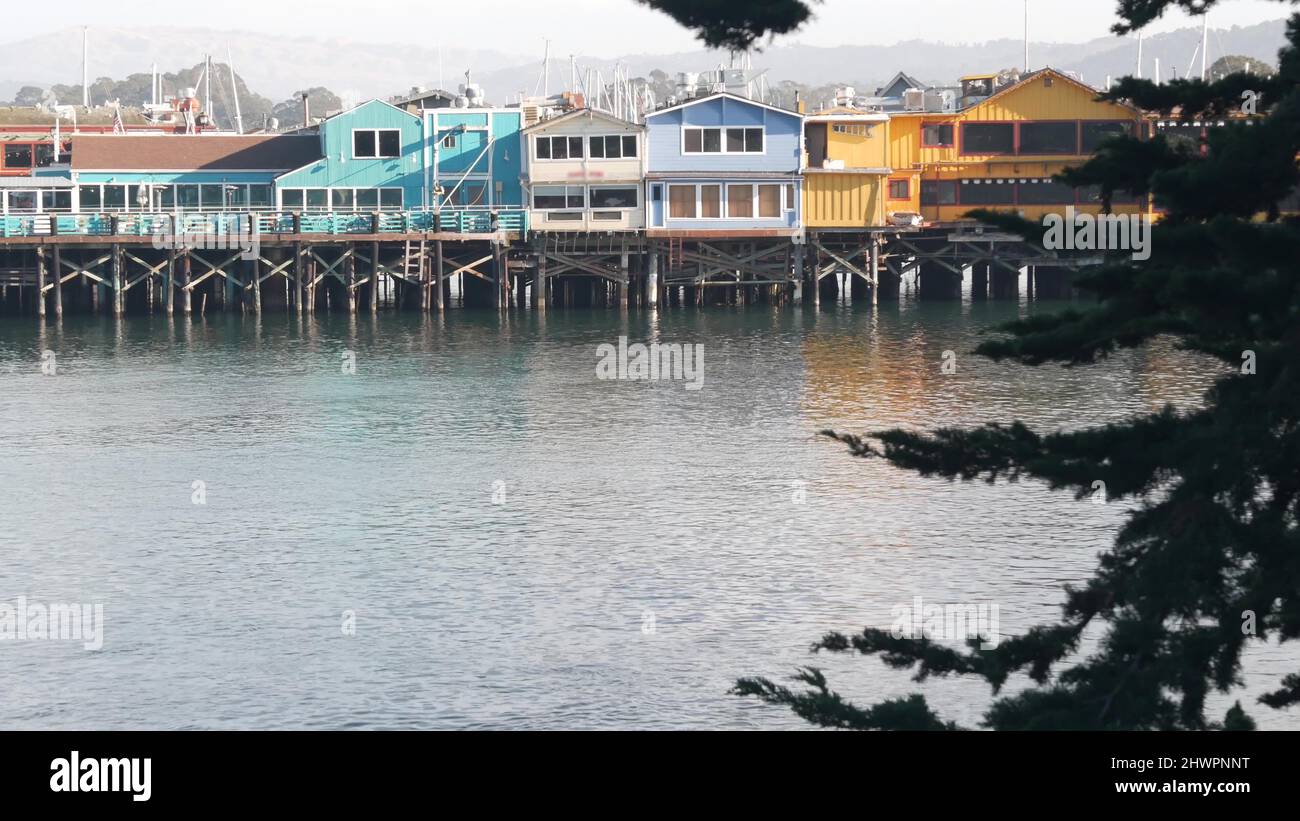 Colorful wooden houses on piles, pillars or pylons, ocean sea water ...