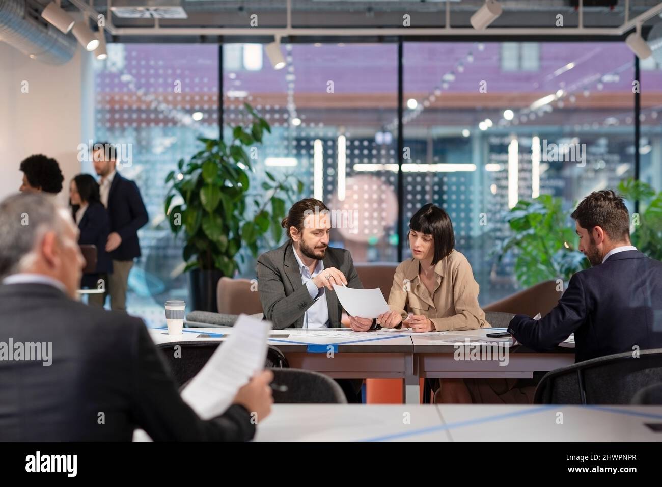 Business people working on documents in coworking space Stock Photo - Alamy