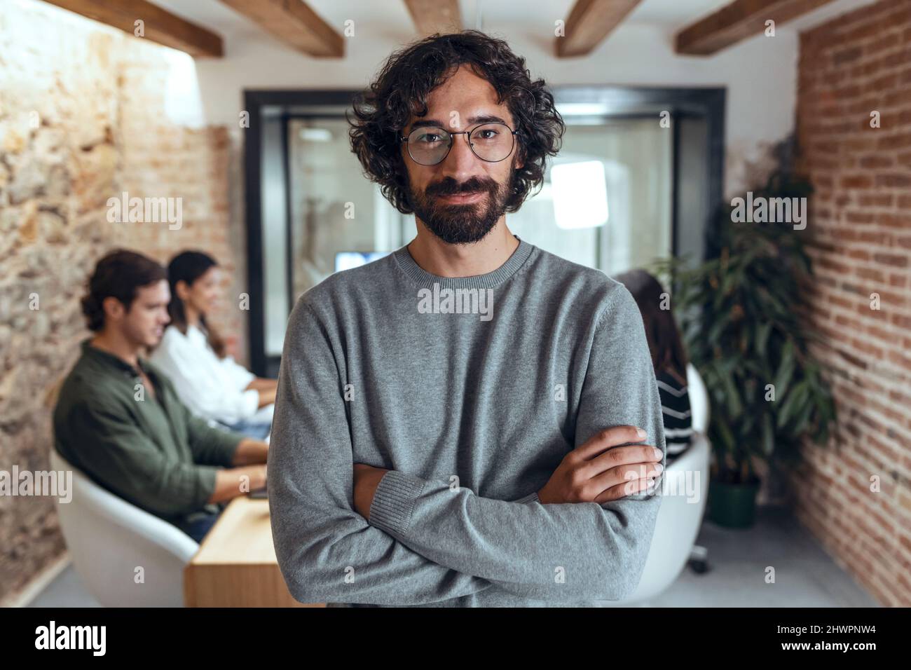 Confident businessman with arms crossed in board room Stock Photo - Alamy