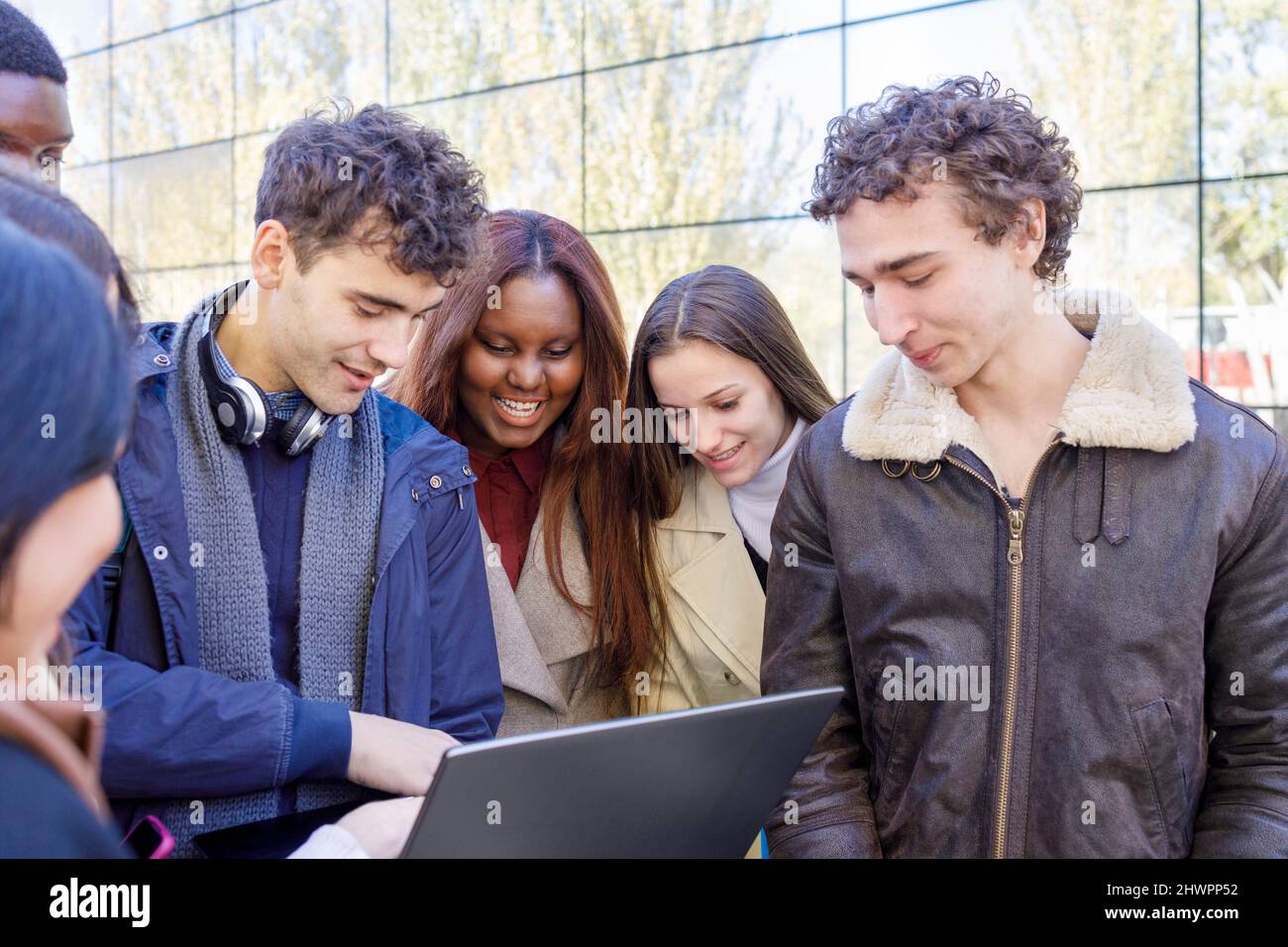 Students sharing laptop on university campus Stock Photo - Alamy
