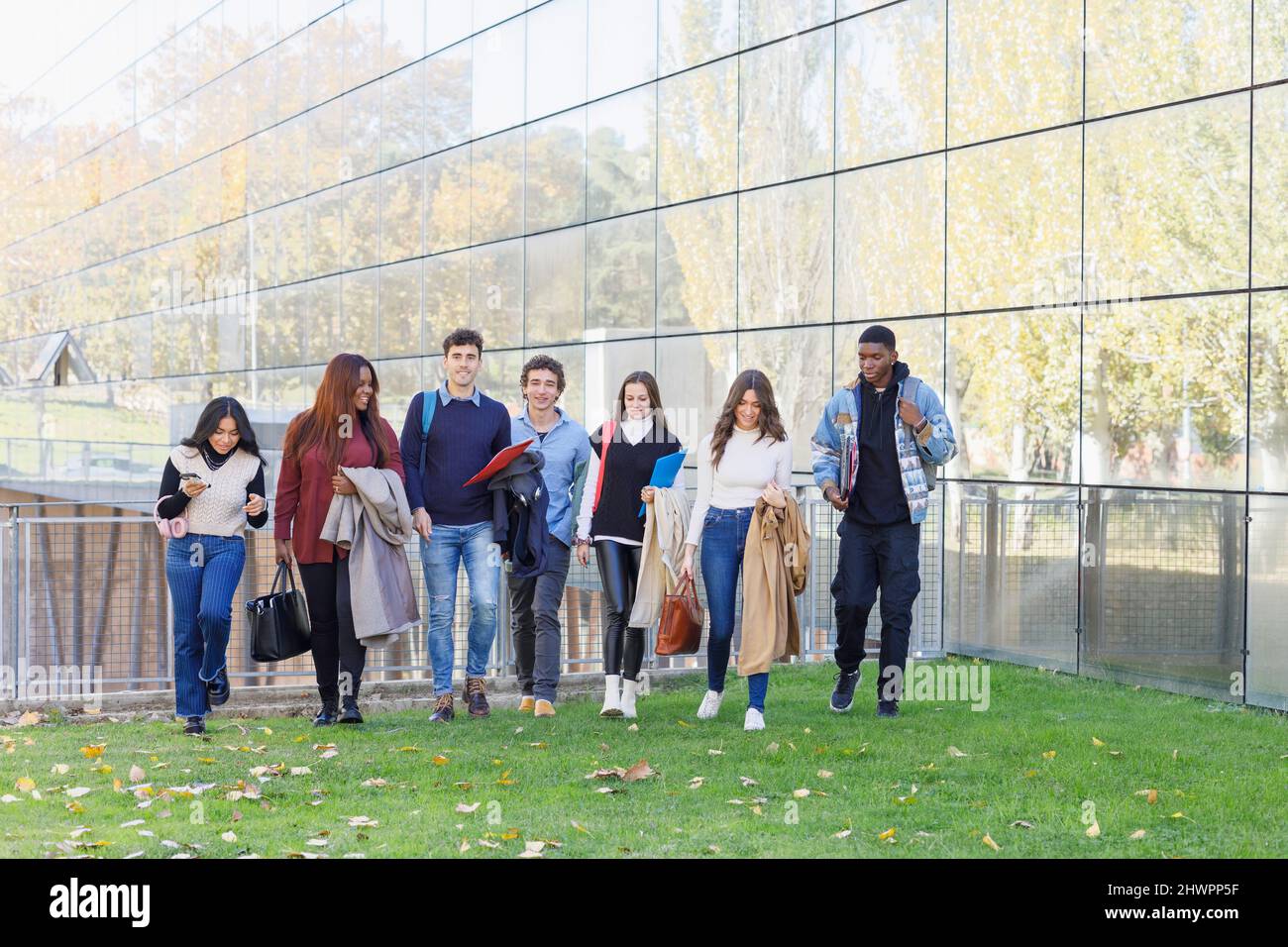 Multiracial students walking on university campus Stock Photo - Alamy