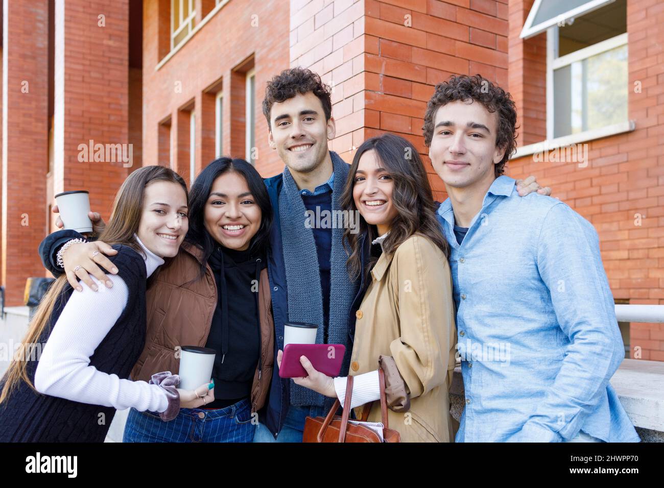 Happy multiracial students standing on college campus Stock Photo - Alamy