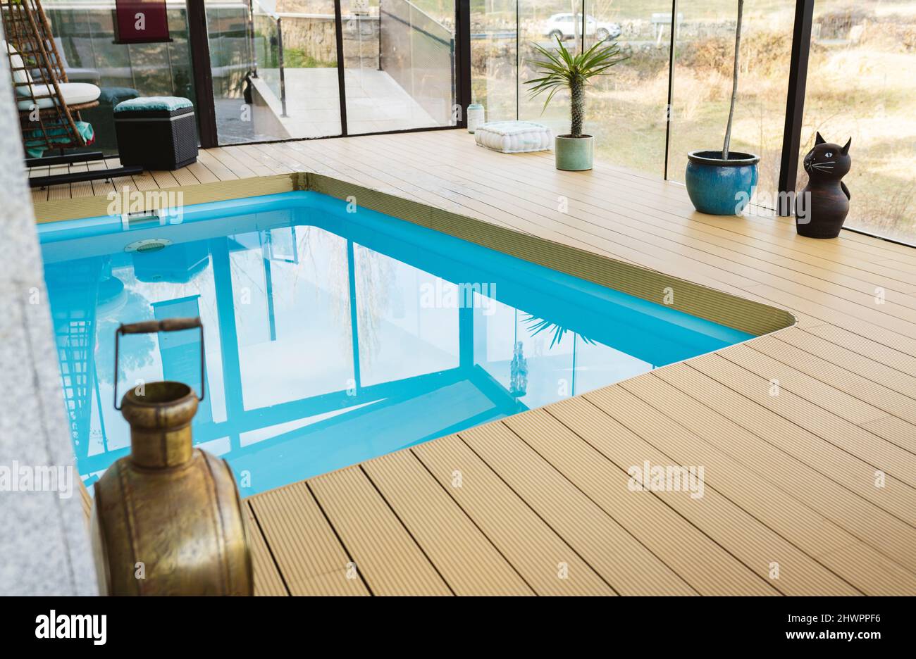 Blue swimming pool in modern home Stock Photo - Alamy