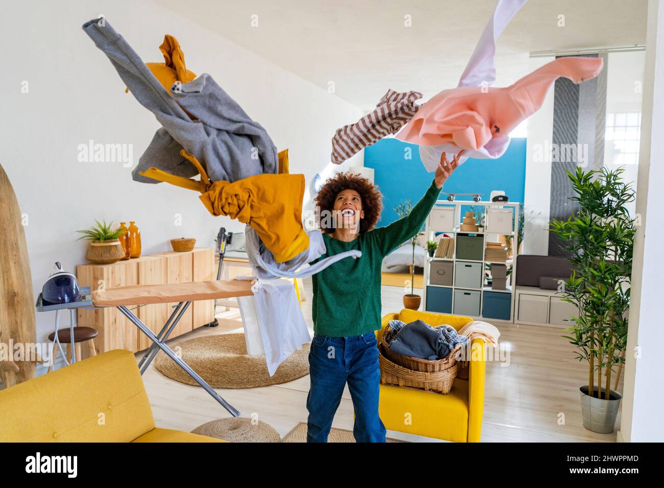 Woman throwing clothes hi-res stock photography and images - Alamy