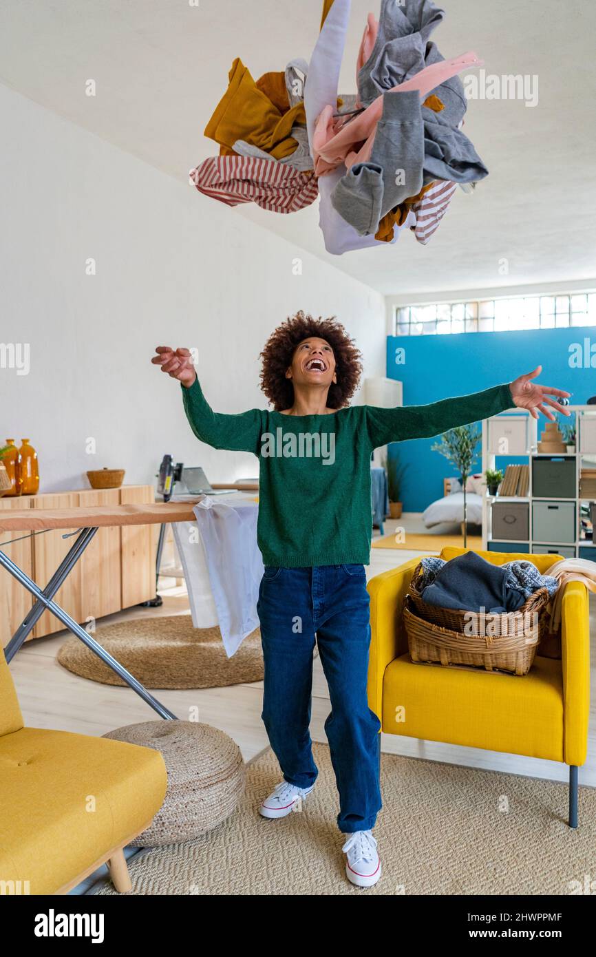 Young woman throwing clothes hi-res stock photography and images - Alamy