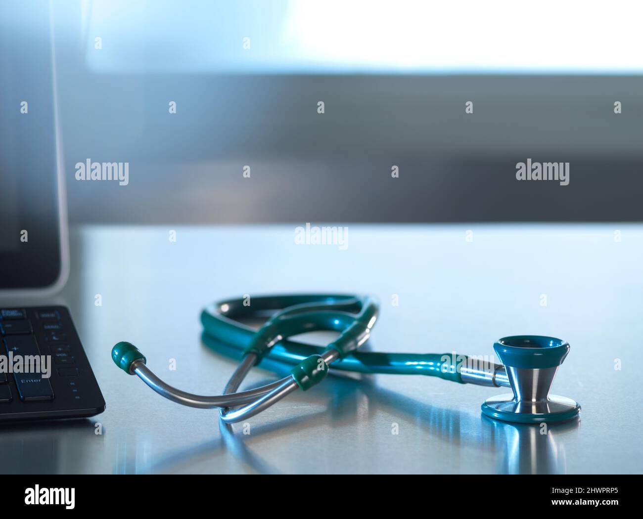 Stethoscope by computer keyboard on desk at medical clinic Stock Photo ...