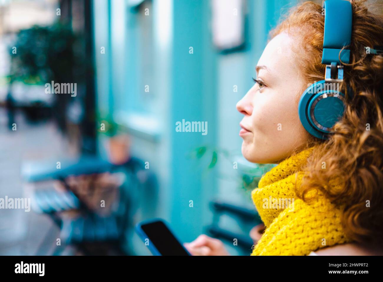 Thoughtful woman listening music hi-res stock photography and images ...