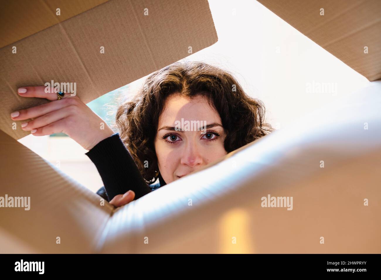 Woman opening cardboard box Stock Photo - Alamy