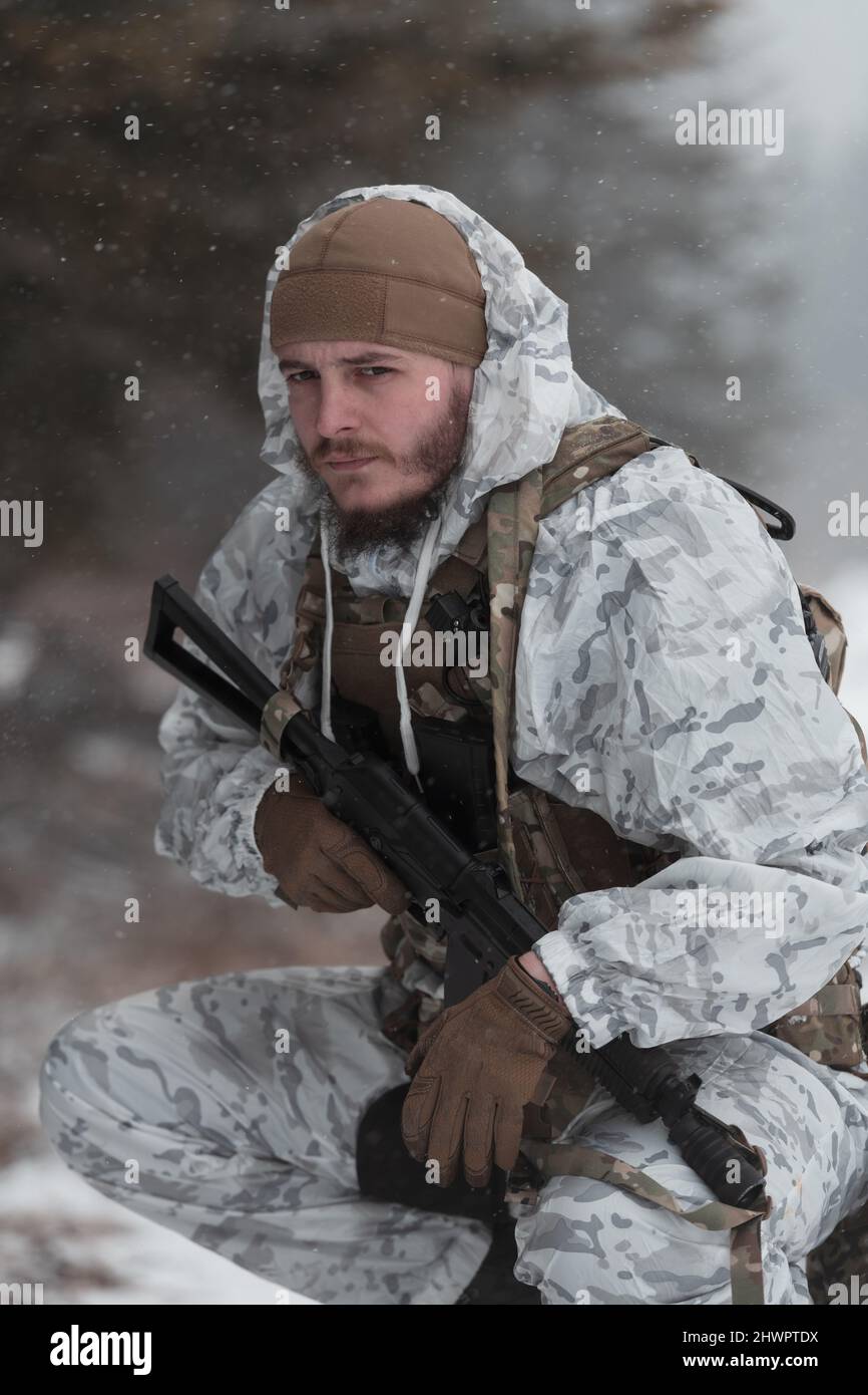 Soldier in winter camouflaged uniform in Modern warfare army on a snow ...
