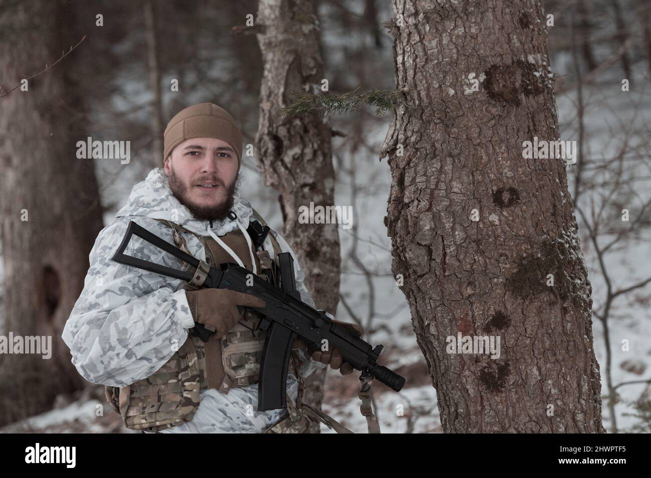 Soldier in winter camouflaged uniform in Modern warfare army on a snow ...
