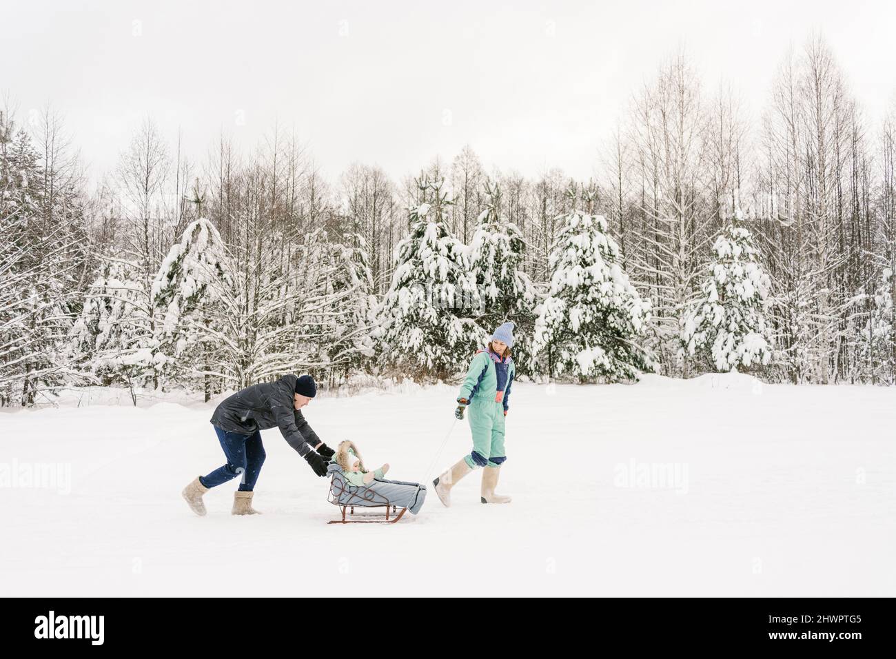 Playful parents with daughter in winter Stock Photo - Alamy