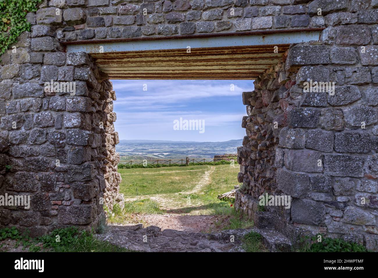 Entrance opening in an ancient thick brick wall of Radicofani fortress ...