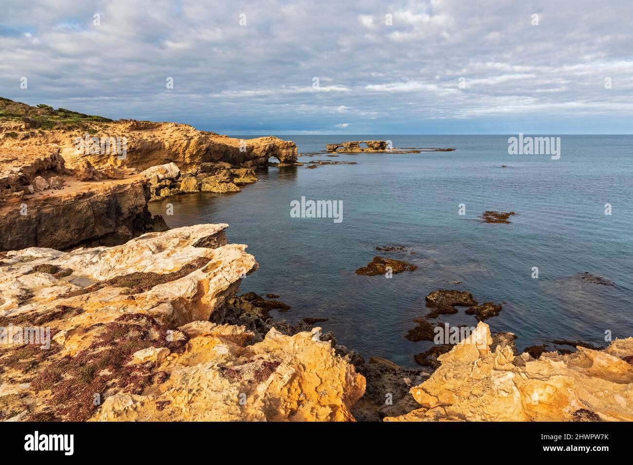 Rough coastal cliffs natural arch background hi-res stock photography ...