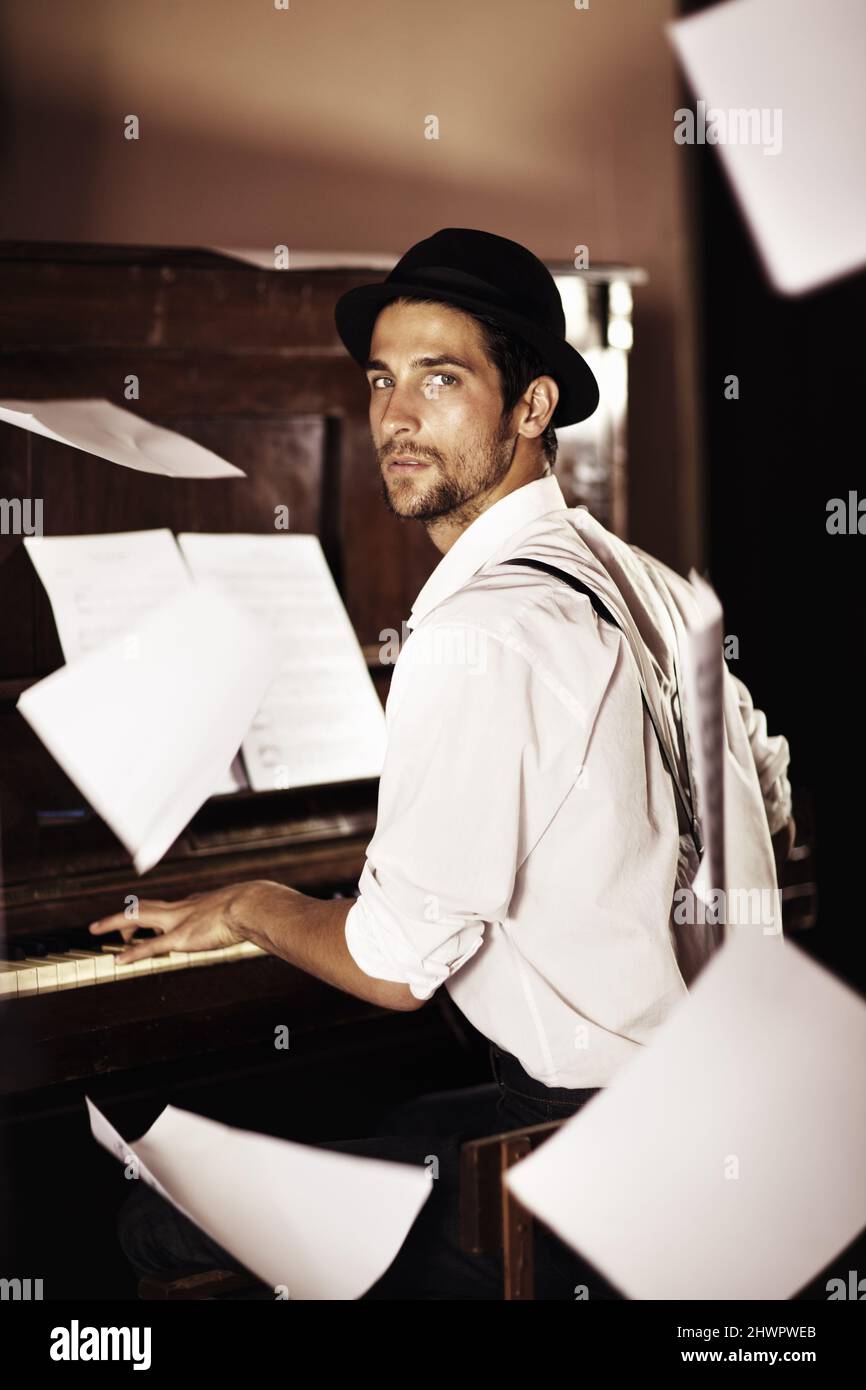 Musical inspiration. Portrait of a handsome young musician sitting at a ...