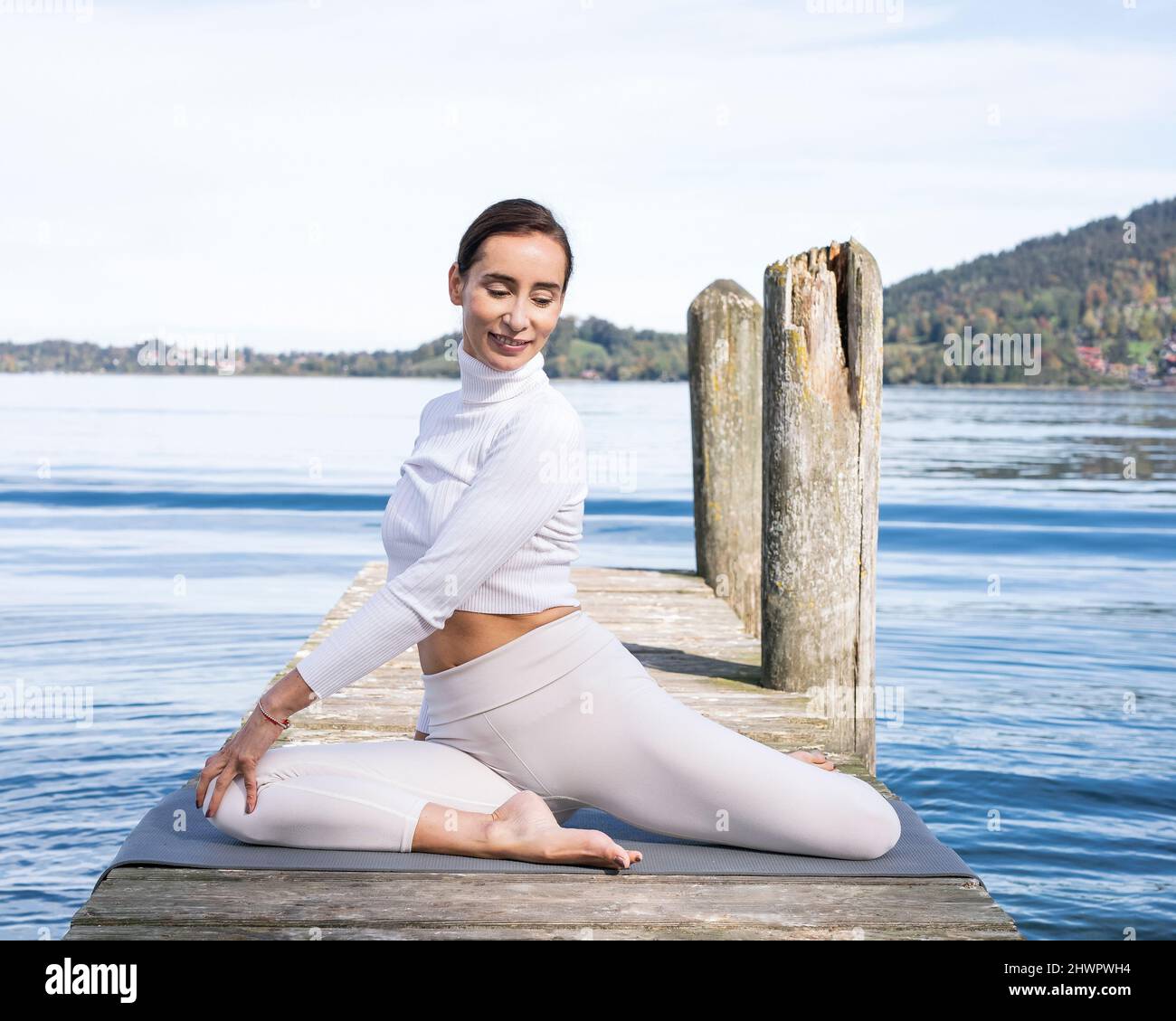 Beautiful woman practicing yoga lake hi-res stock photography and ...
