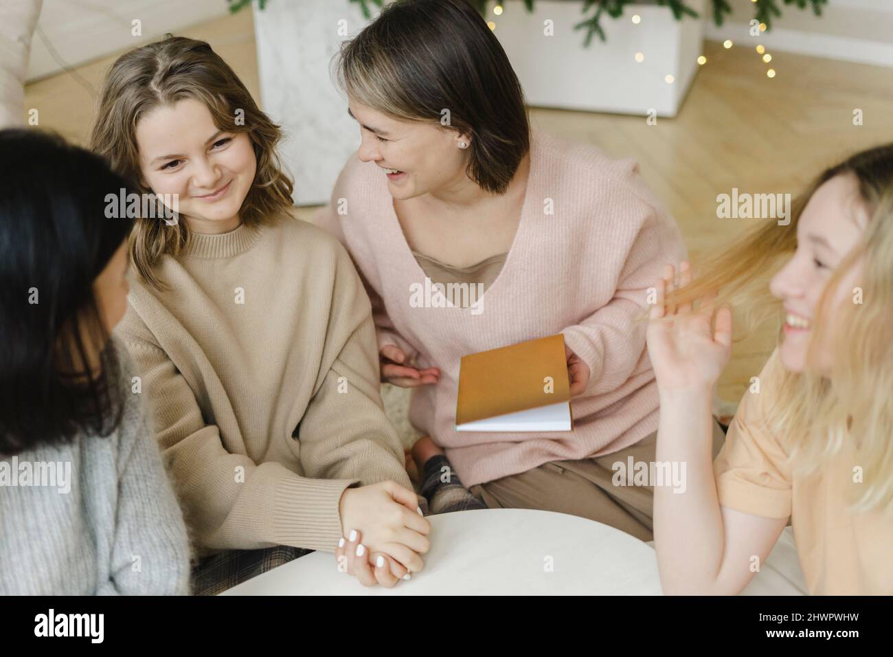 Cheerful women talking with their daughters at home Stock Photo - Alamy