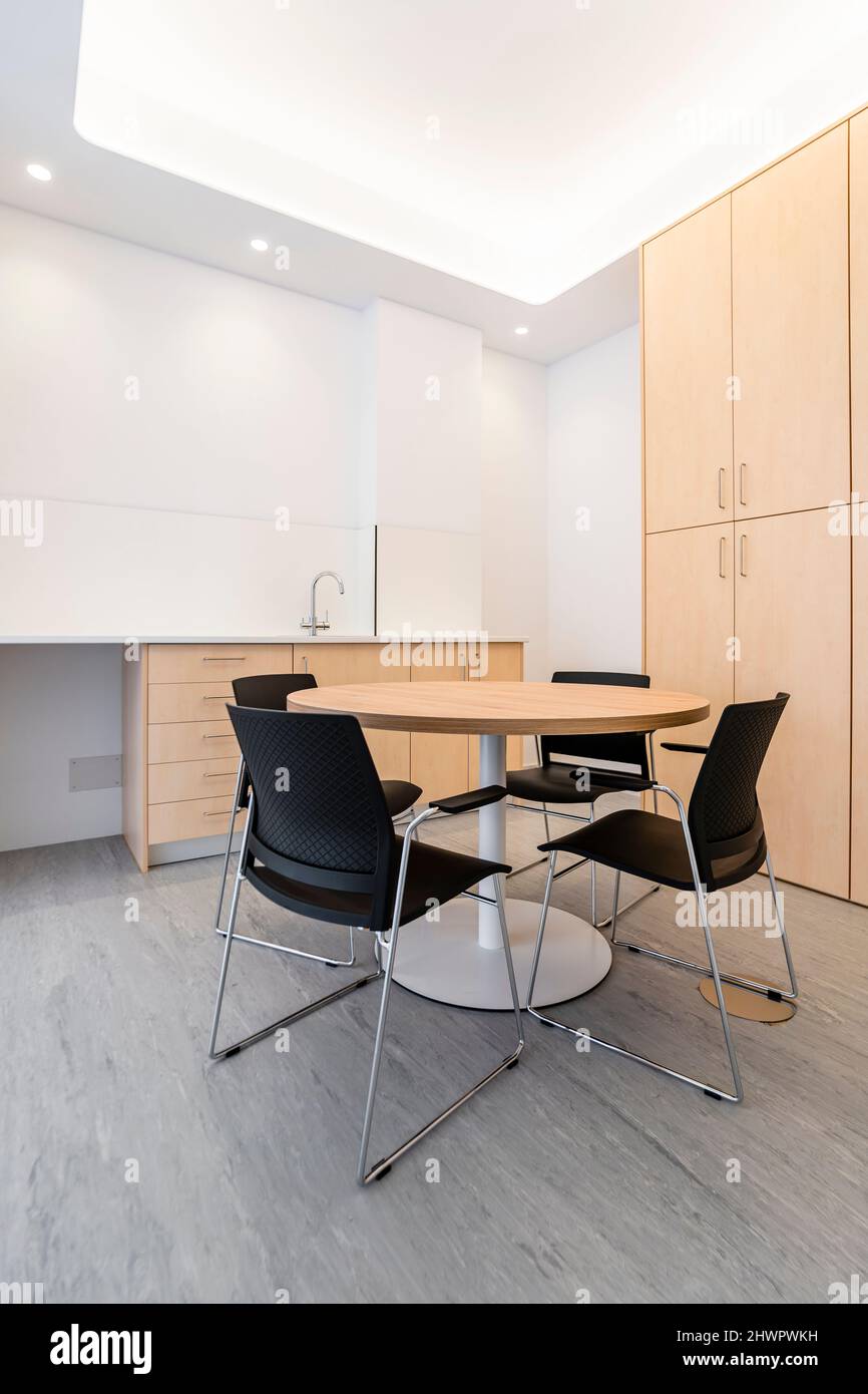 Chairs arranged by table in medical clinic Stock Photo - Alamy