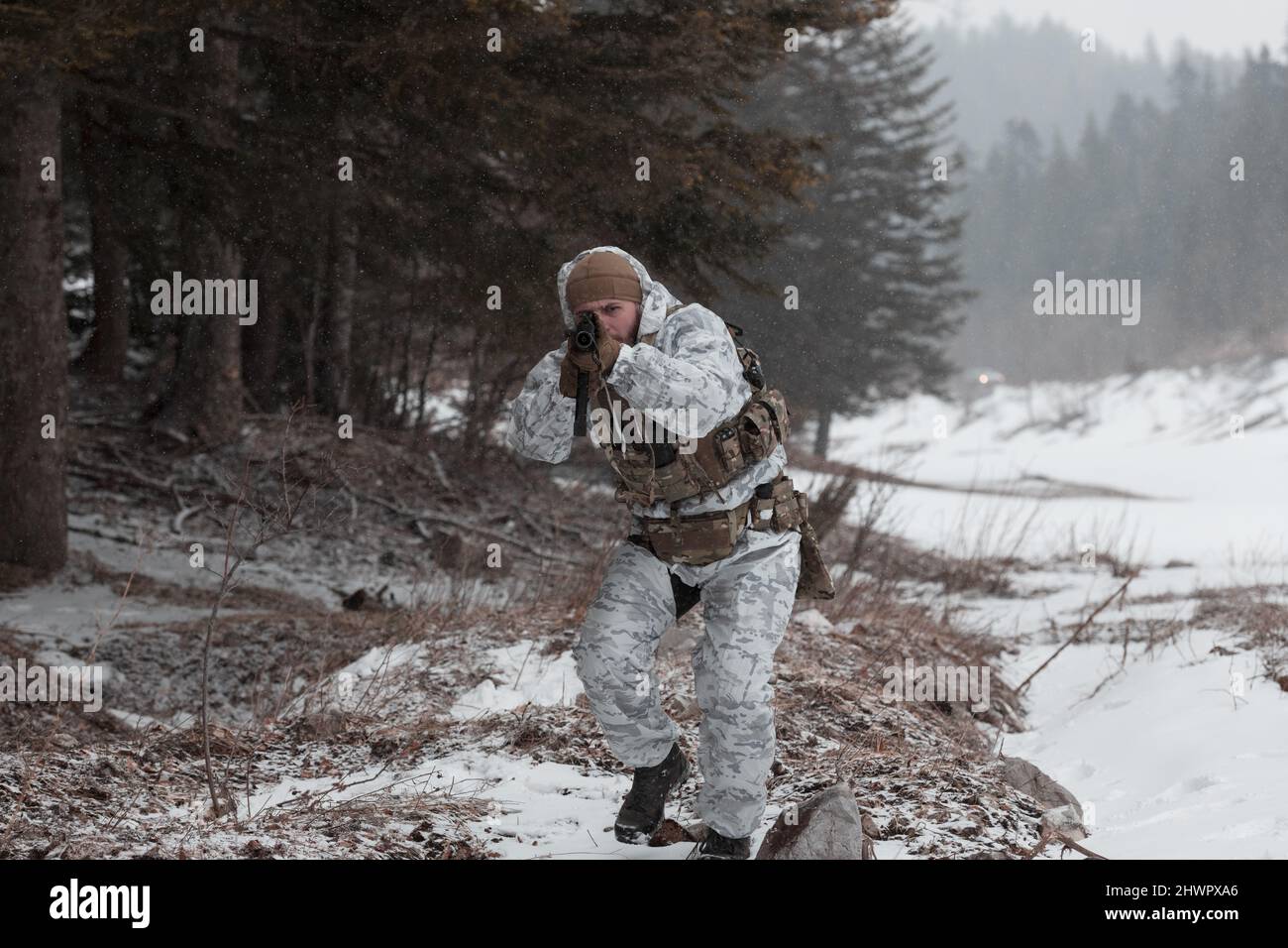 Soldier in winter camouflaged uniform in Modern warfare army on a snow ...