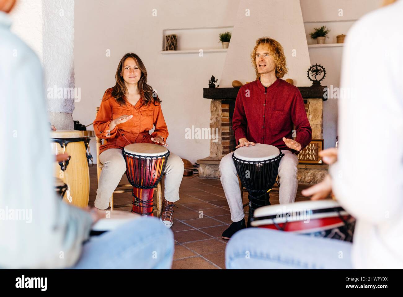 Multiracial friends playing bongo in classroom Stock Photo - Alamy