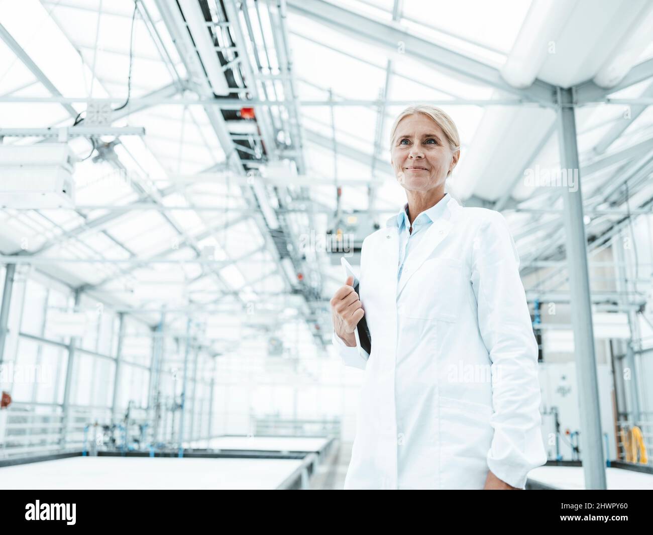 Contemplative biologist with lab coat in laboratory Stock Photo - Alamy