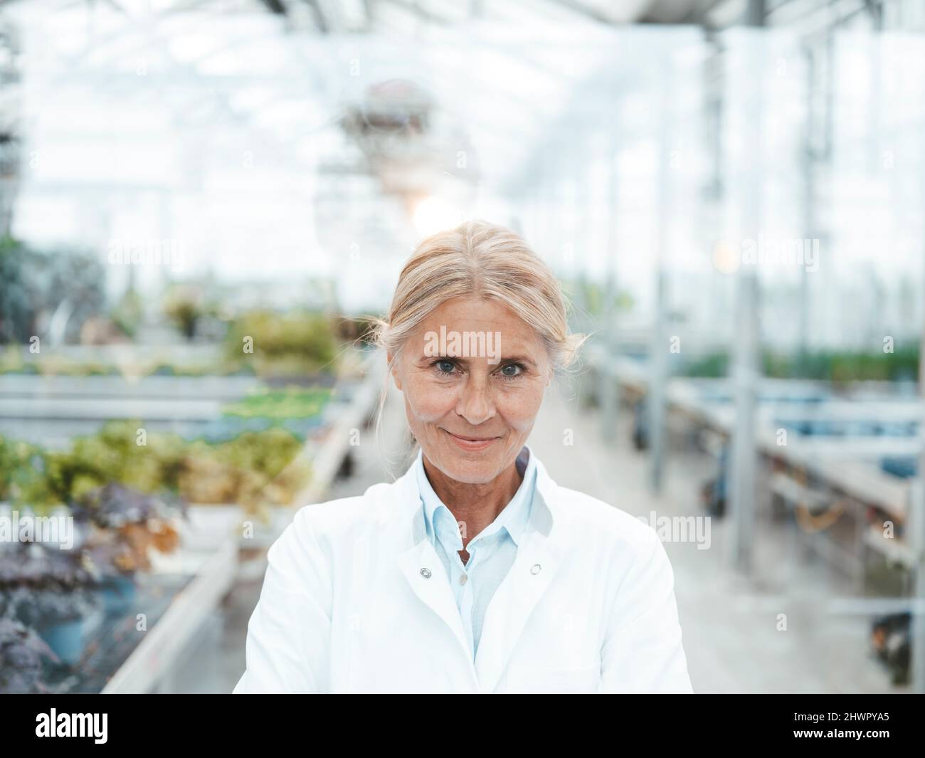 Smiling biologist at greenhouse laboratory Stock Photo - Alamy