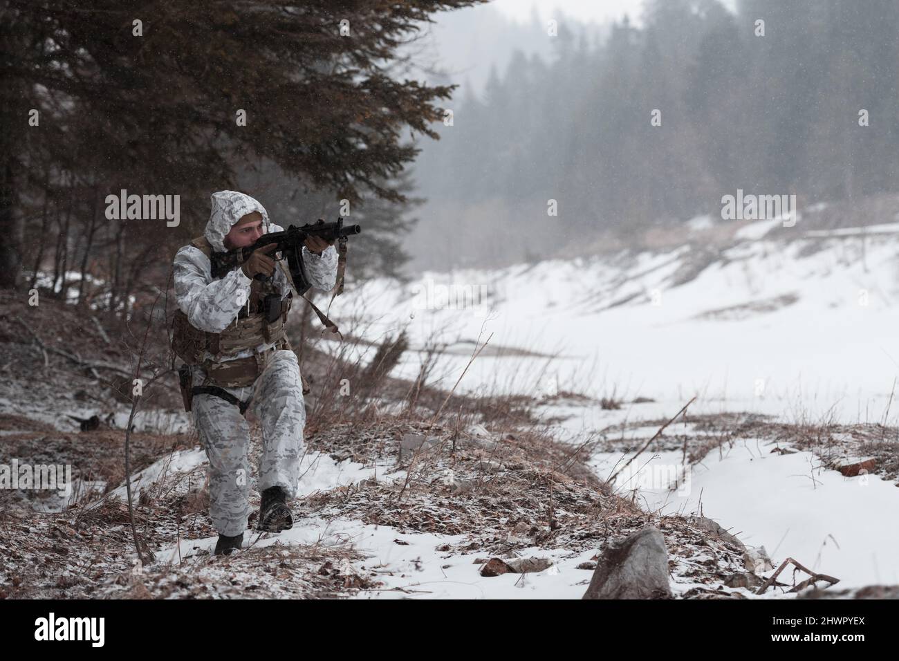 Soldier in winter camouflaged uniform in Modern warfare army on a snow ...