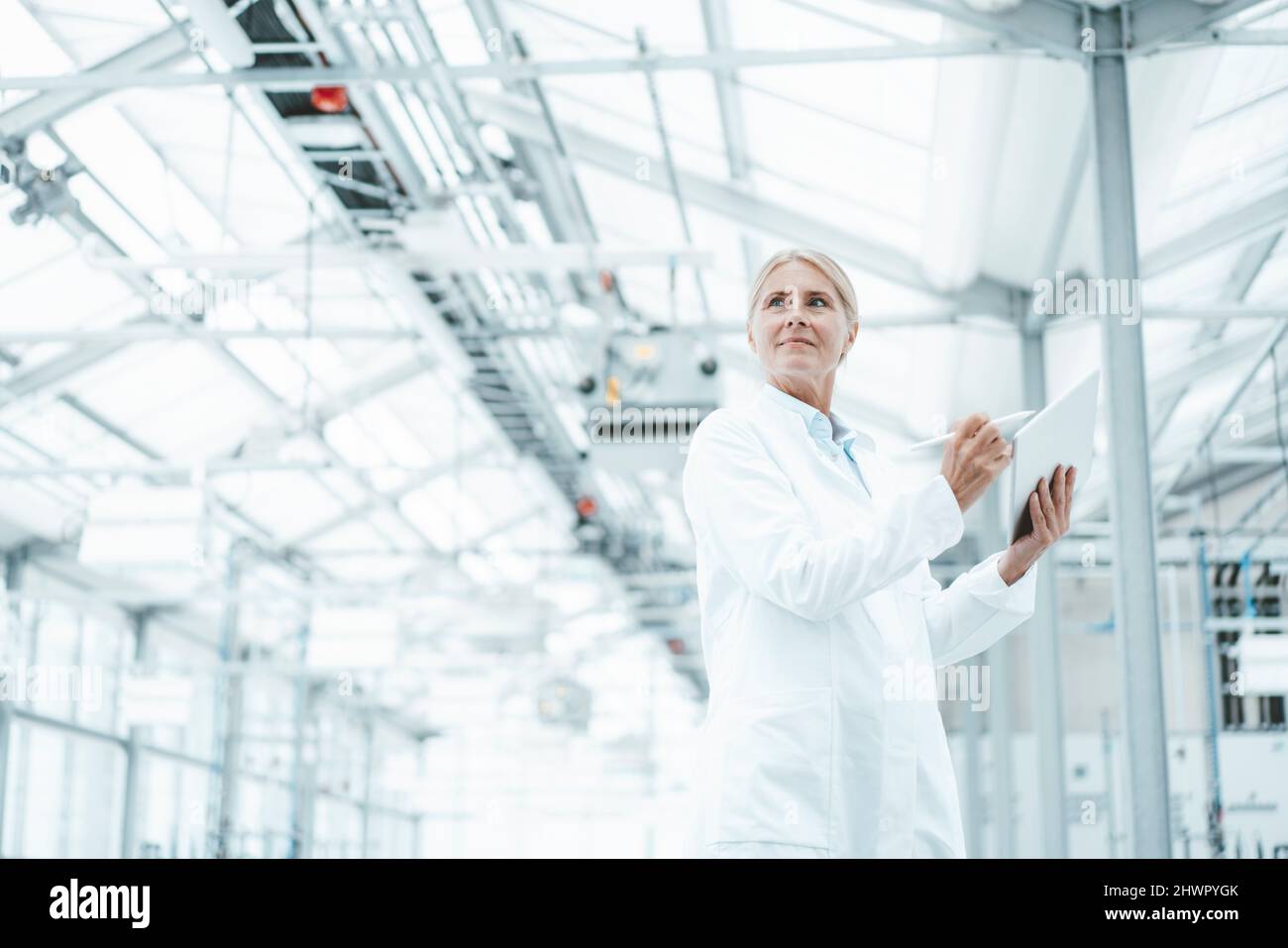 Thoughtful scientist in white lab coat at laboratory Stock Photo - Alamy