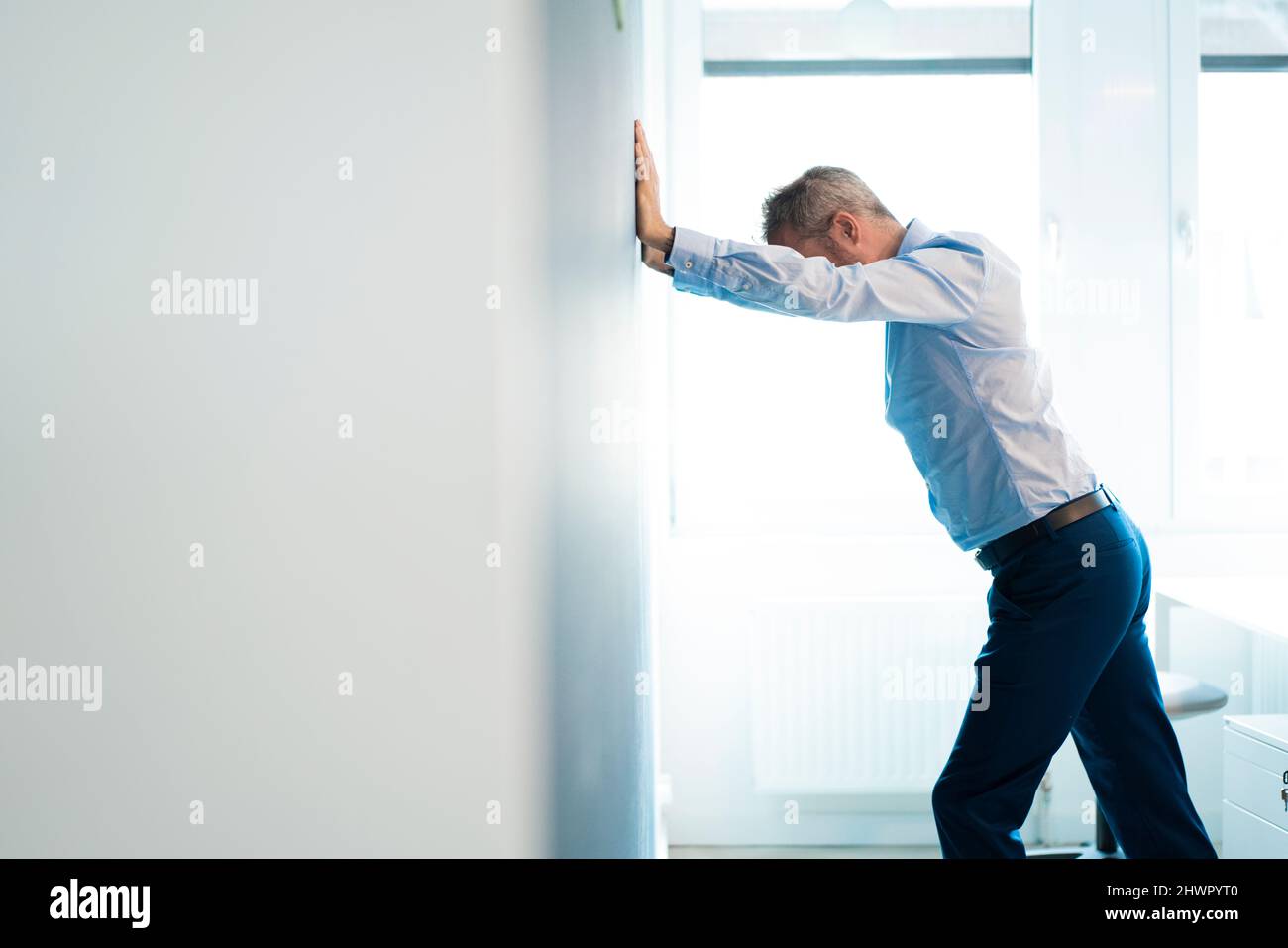 Tired man leaning on wall hi-res stock photography and images - Alamy