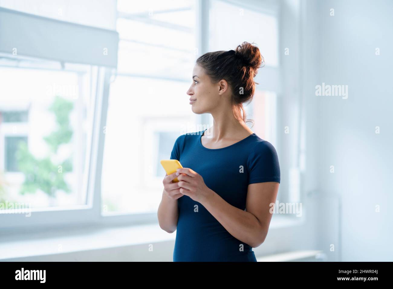 Smart dress looking out window hi-res stock photography and images - Alamy