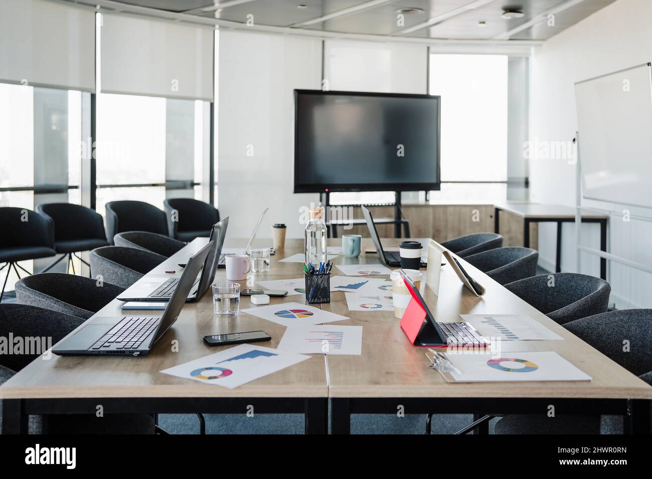 Laptops and graphs kept on conference table in empty meeting room Stock ...