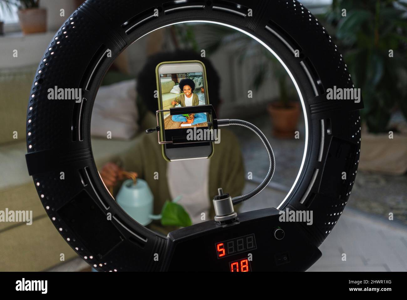 Smart phone in ring light filming woman at home Stock Photo - Alamy