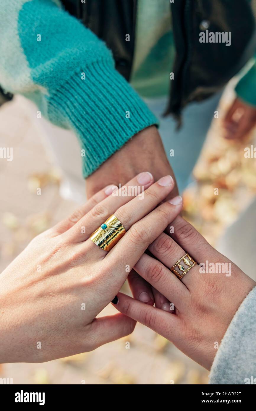 Young women stacking hands Stock Photo - Alamy