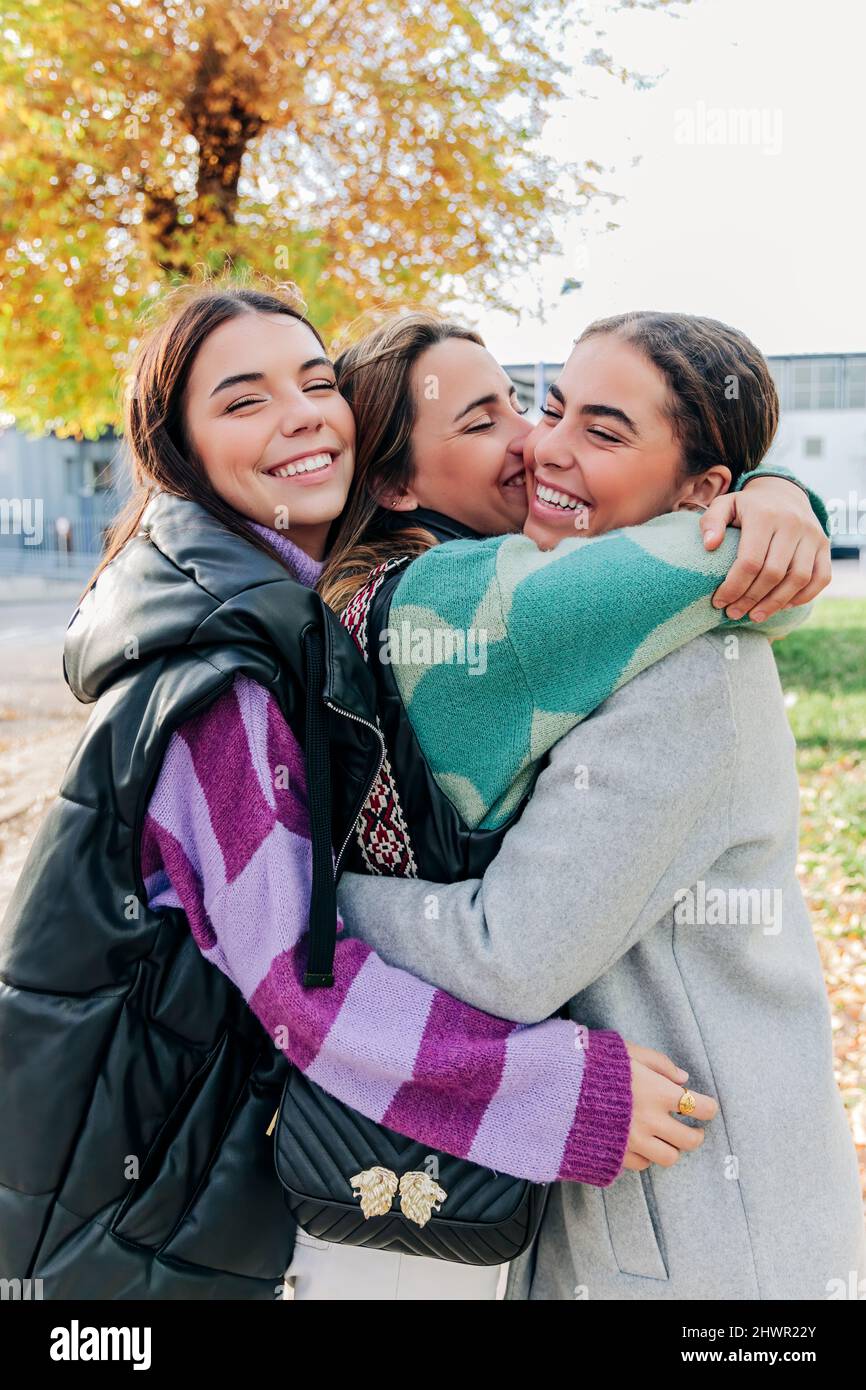 Smiling friends embracing on hi-res stock photography and images - Alamy