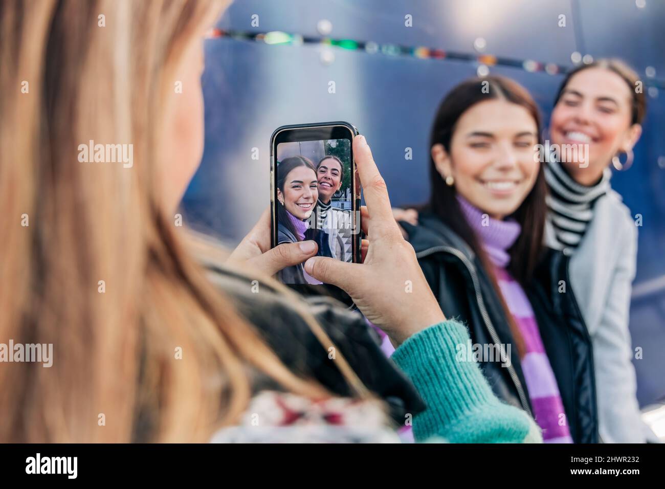 Woman photographing friends smart hi-res stock photography and images ...