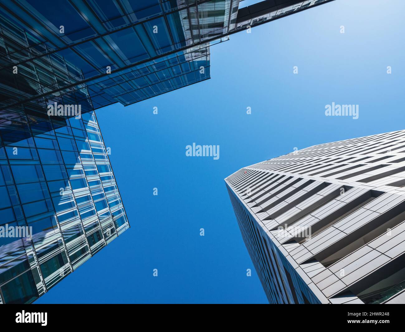 Bottom-up view of modern skyscrapers over blue sky background Stock ...
