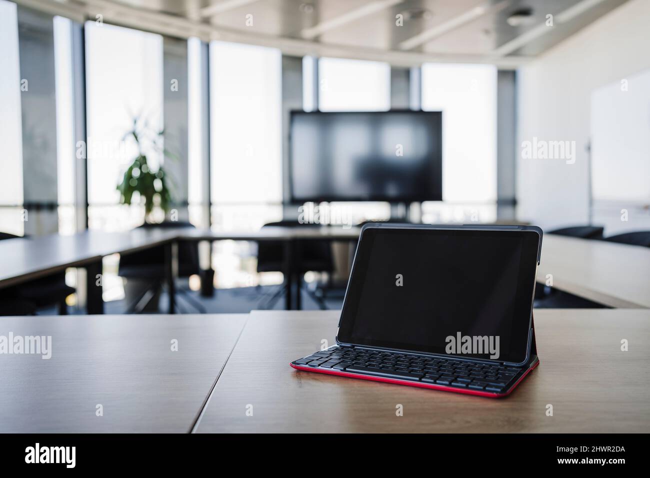 Laptop on table in conference room at office Stock Photo - Alamy