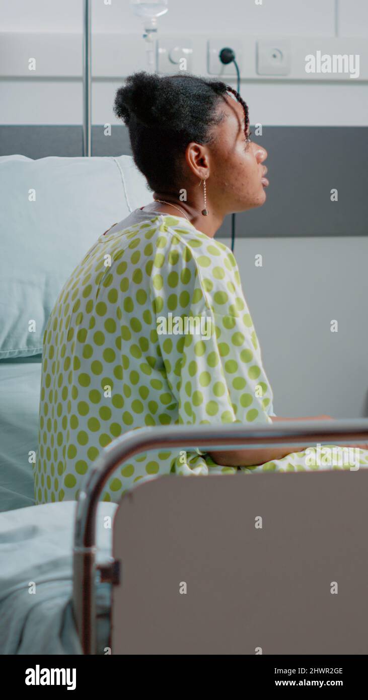 African american patient with sickness sitting in hospital ward bed ...