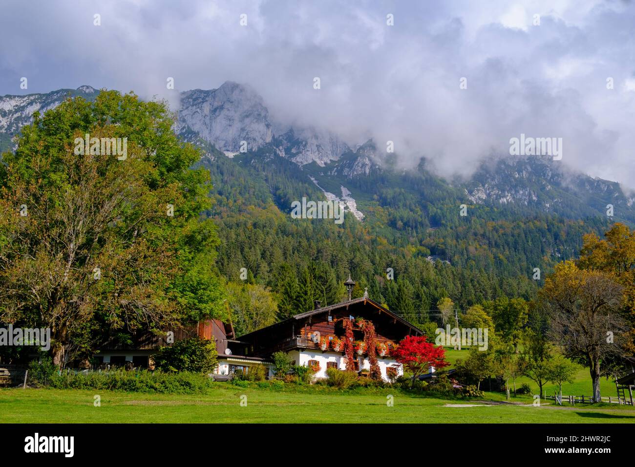 Austria, Tirol, Clouds over farmhouse in Kaiser Mountains Stock Photo ...